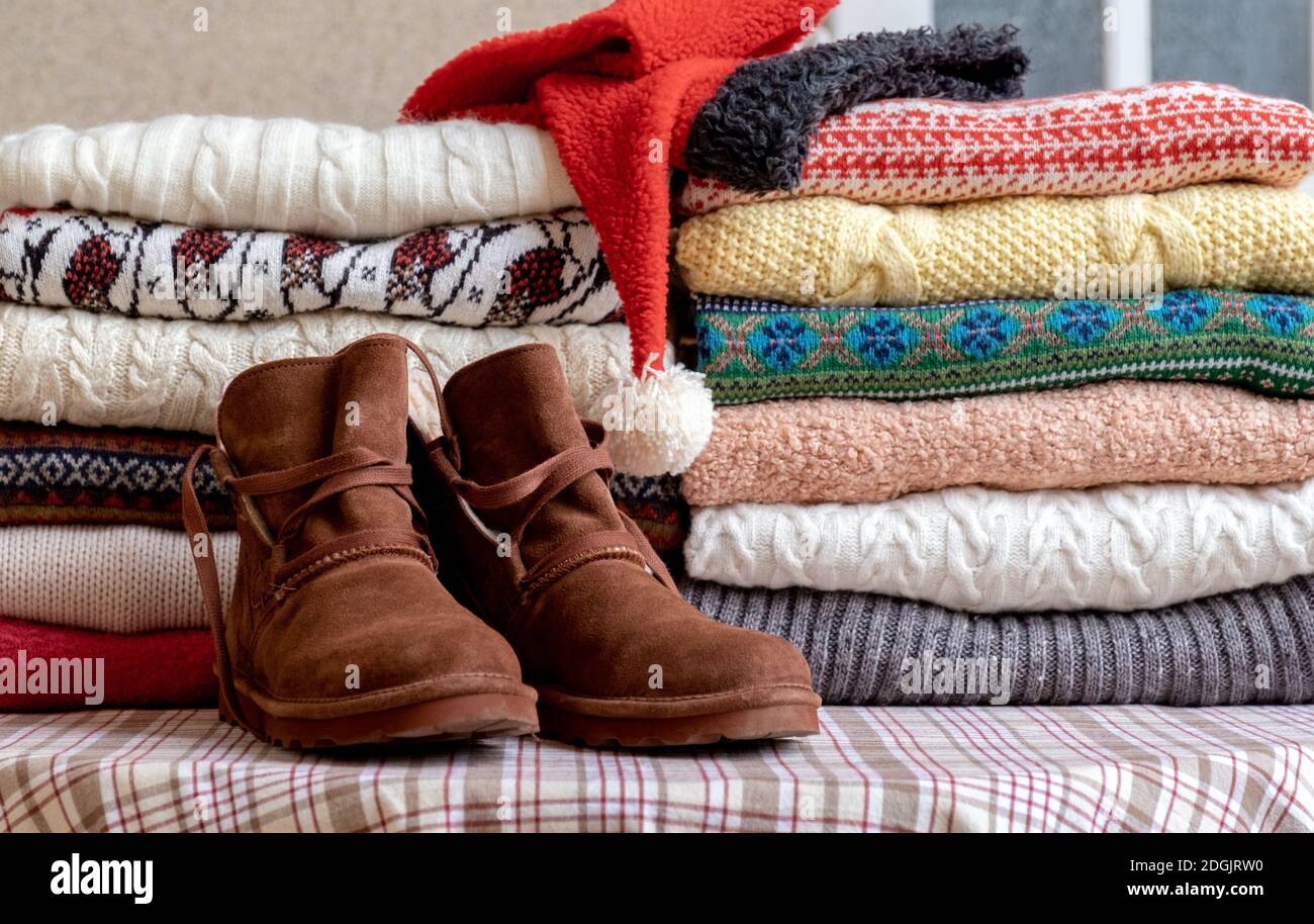 A Lot of Sweaters and Pullovers Different Colours folded in two Piles ...