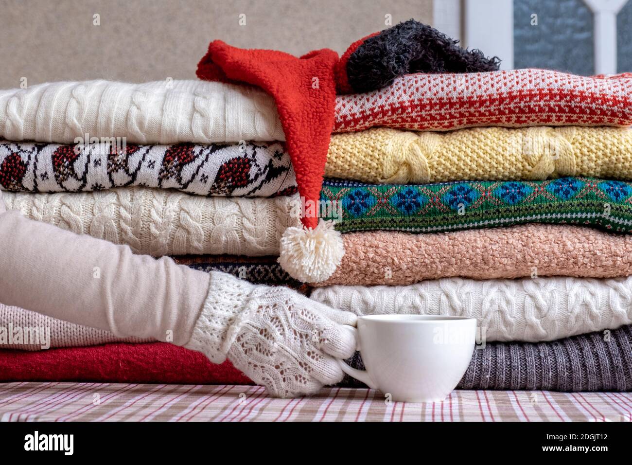 A Lot of Sweaters and Pullovers Different Colours folded in two Piles ...