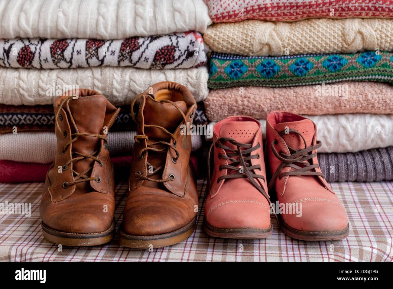 A Lot of Sweaters and Pullovers Different Colours folded in two Piles ...