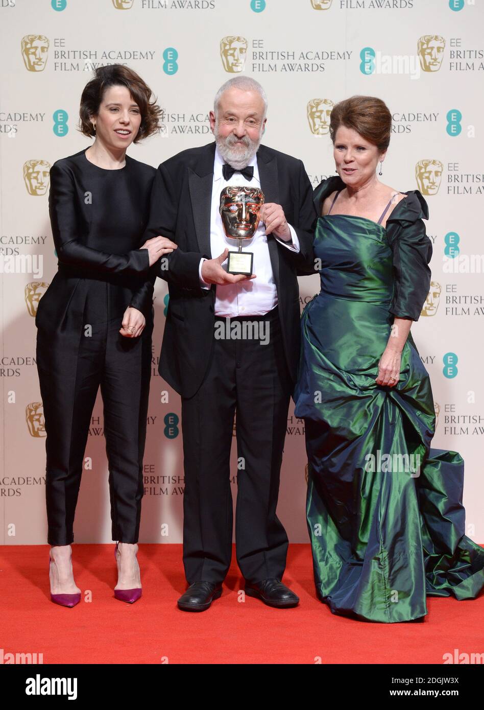 Mike Leigh winner of the BAFTA Fellowship, poses with presenters Sally ...