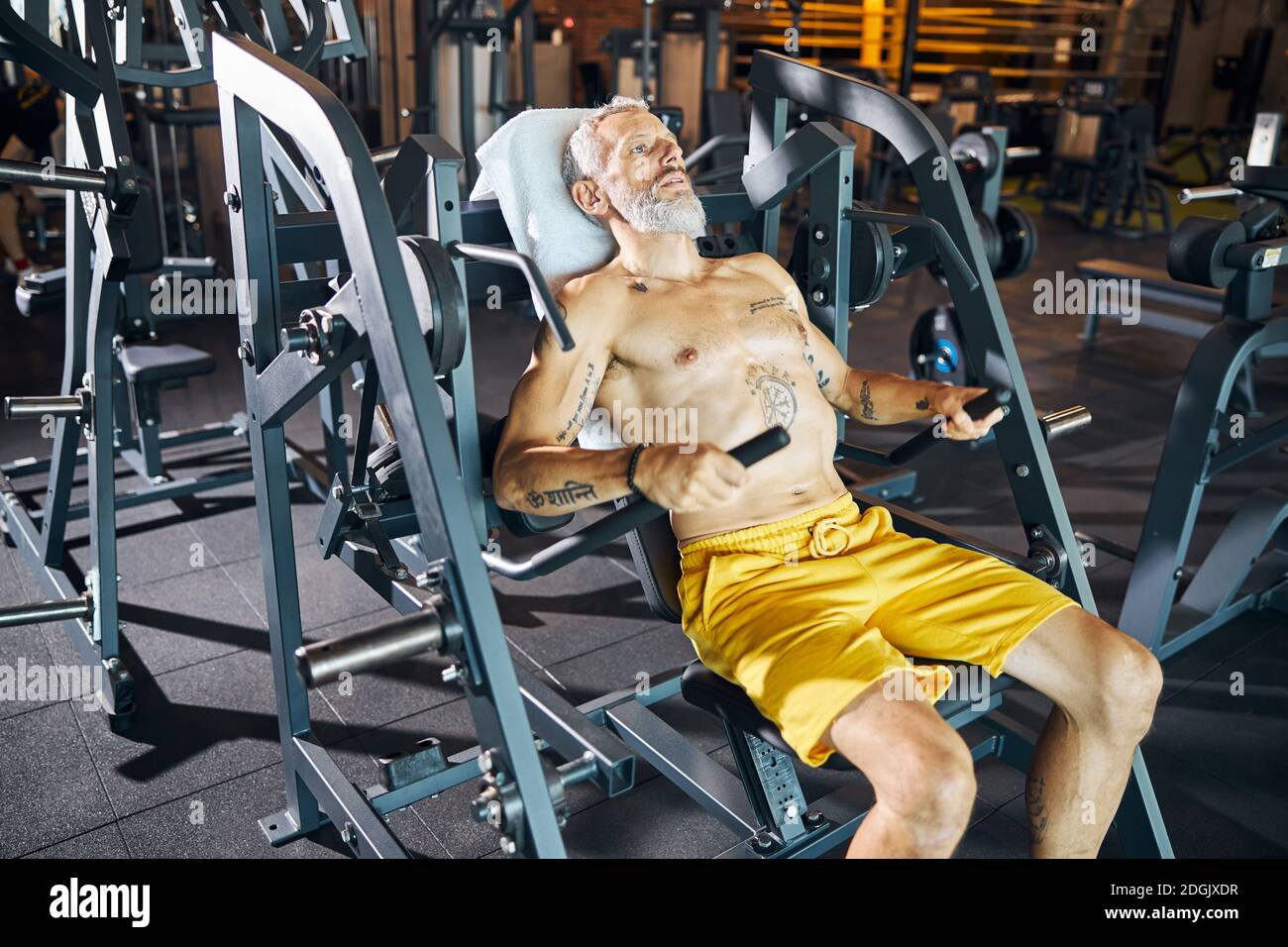 Professional athlete building muscles on an exercise machine Stock ...