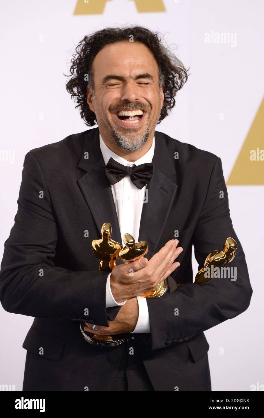 Alejandro G. Inarritu clutches his three Oscar statues for Best ...