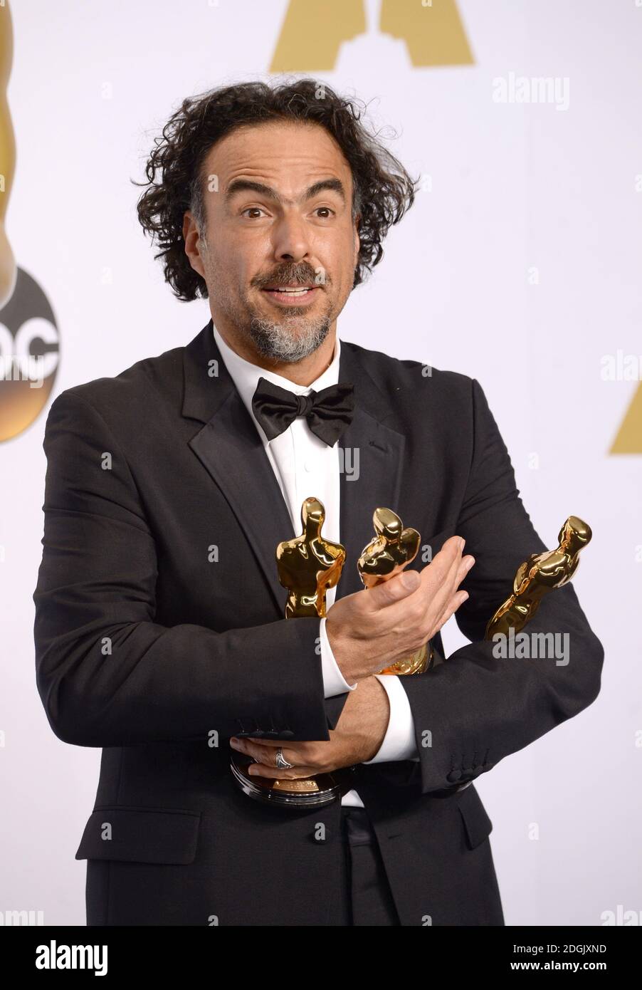 Alejandro G. Inarritu clutches his three Oscar statues for Best ...