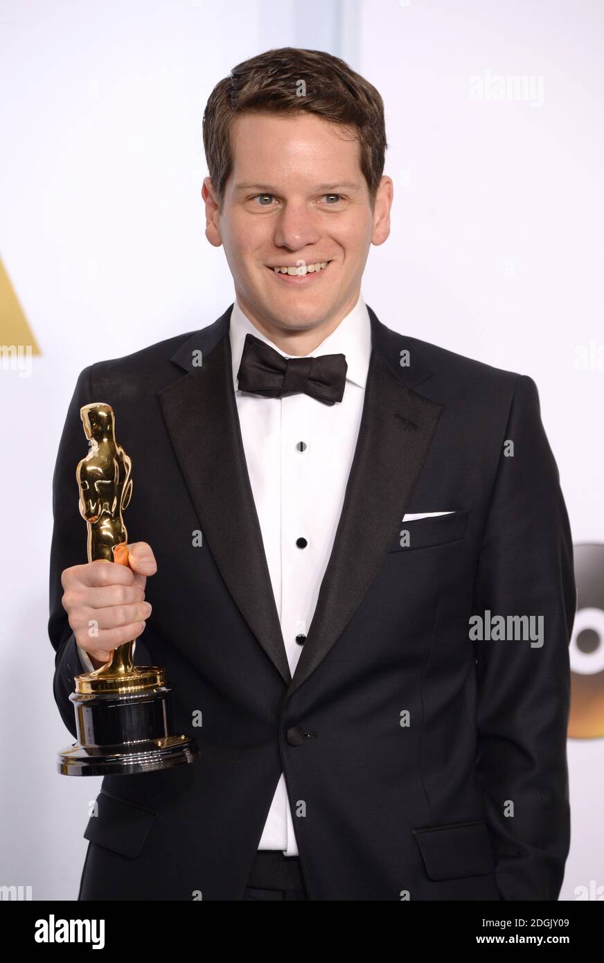 Graham Moore with the award for the best adapted screenplay for 'The ...