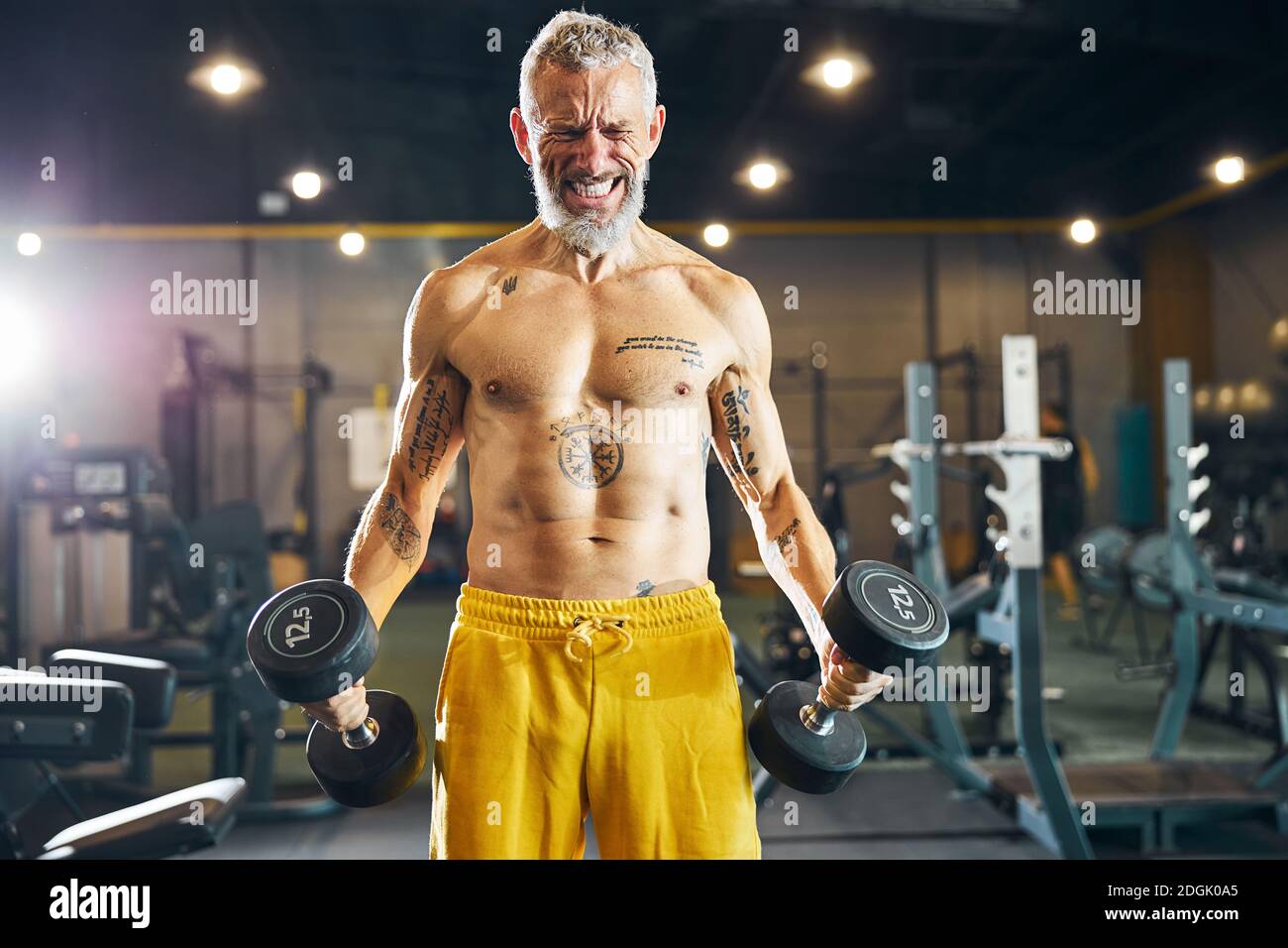Energetic trainer doing a strength training exercise Stock Photo - Alamy