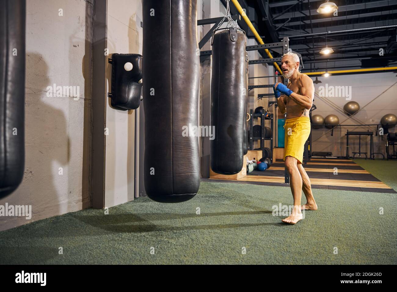 Determined male athlete starting his kickboxing workout Stock Photo - Alamy