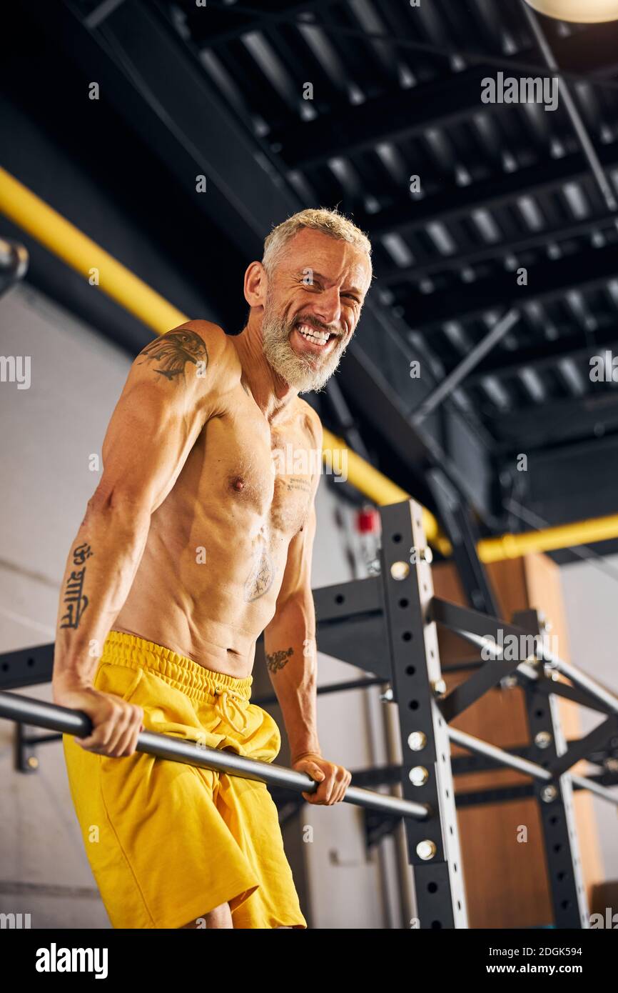 Professional sportsman performing a muscle-up at the gym Stock Photo ...