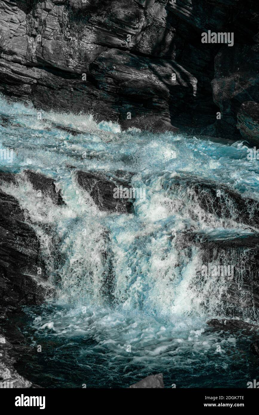Wild and fast moving river rapids white water rushing over rugged ...