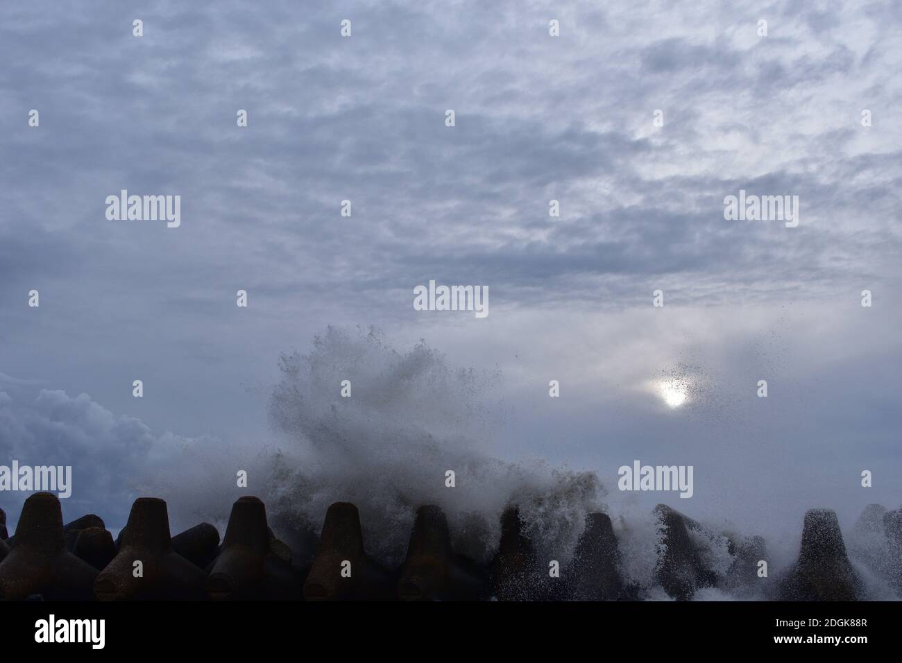 Sea waves hit the cliff and burst into a big splash. Sunset. Grey. Blue ...