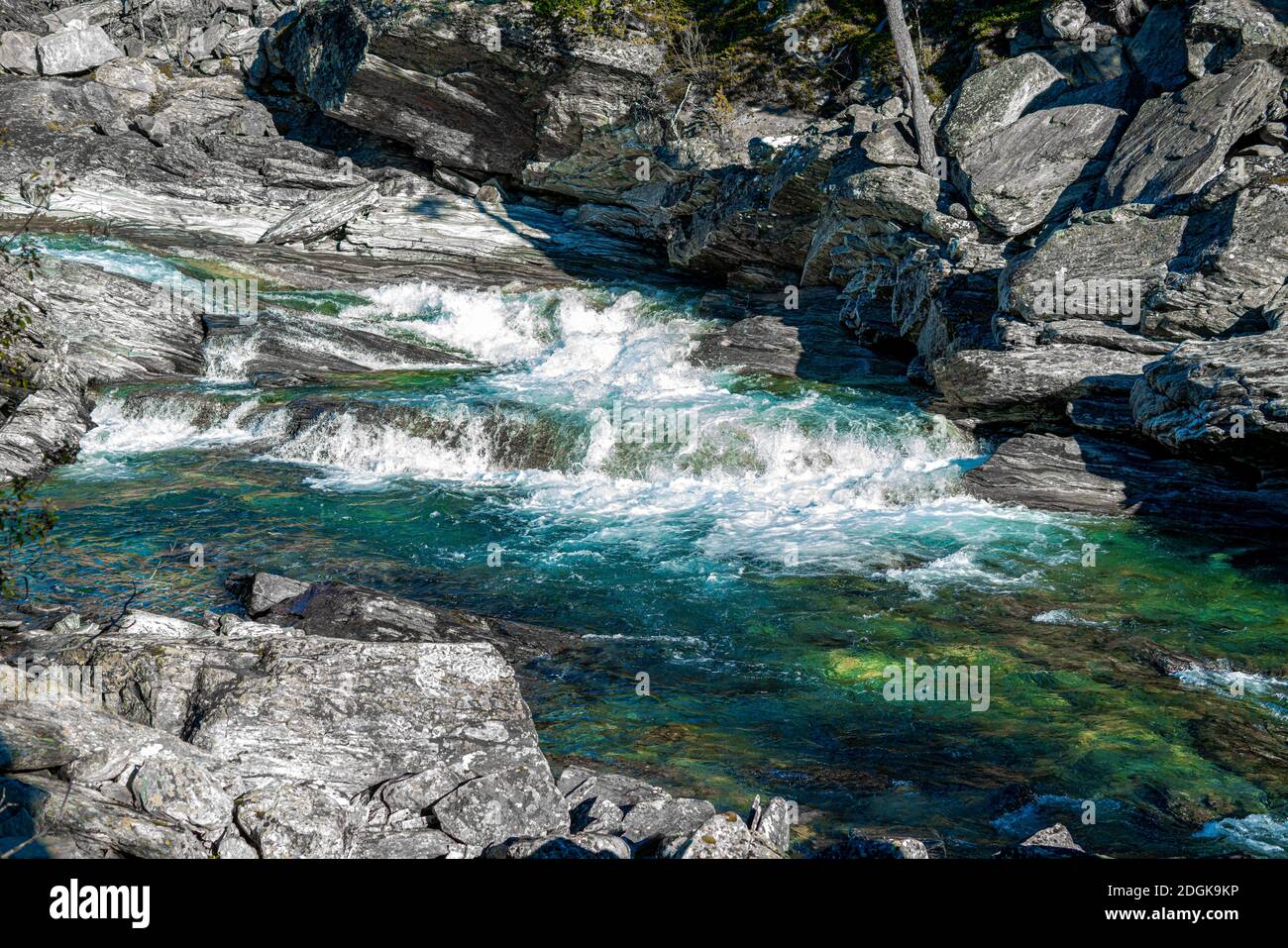 Wild and fast moving river rapids white water rushing over rugged ...