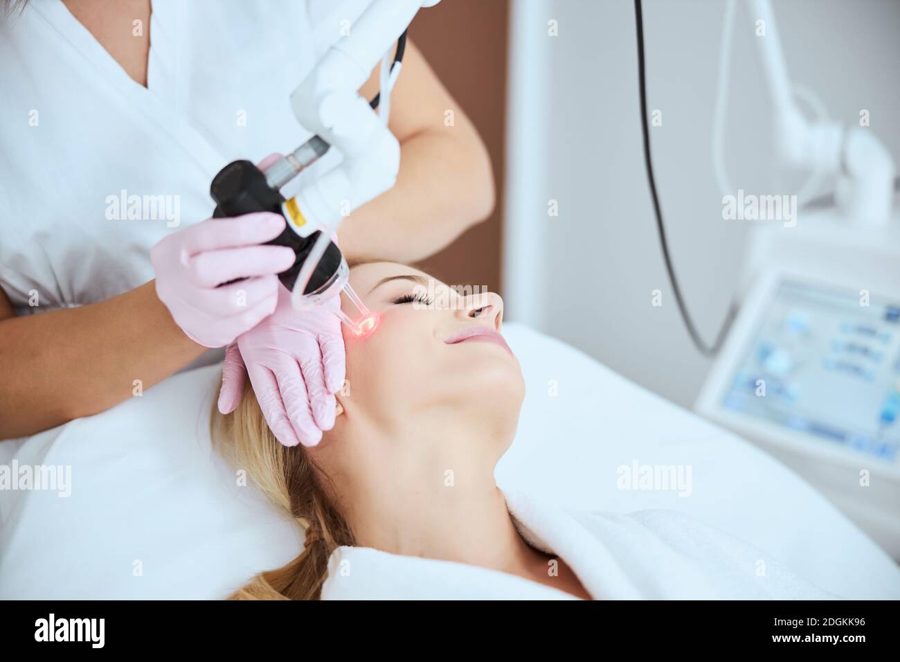 Young woman undergoing a non-invasive cosmetic procedure Stock Photo ...