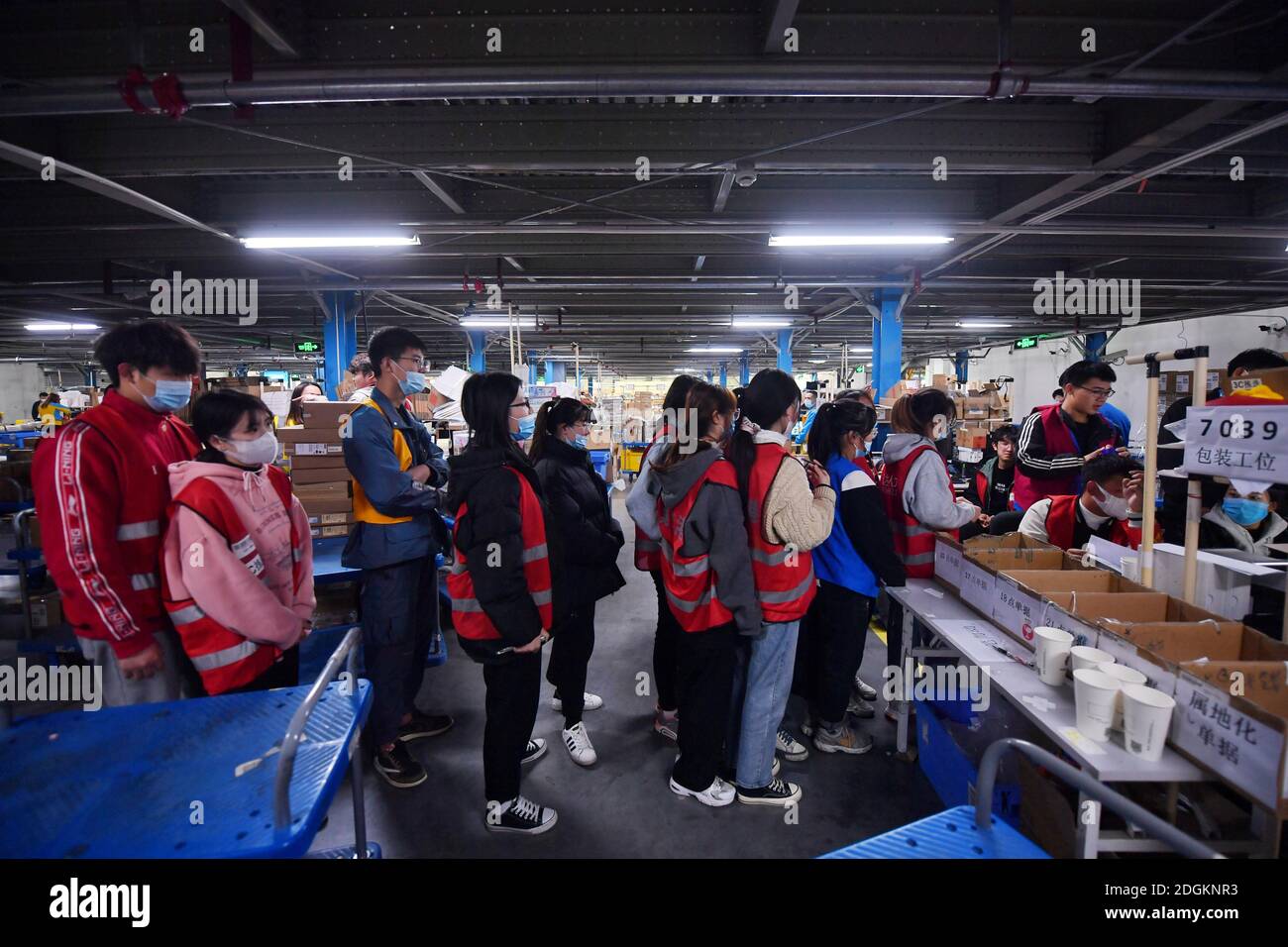 Staff line up to sort piles of deliveries on the Double Eleven Shopping ...