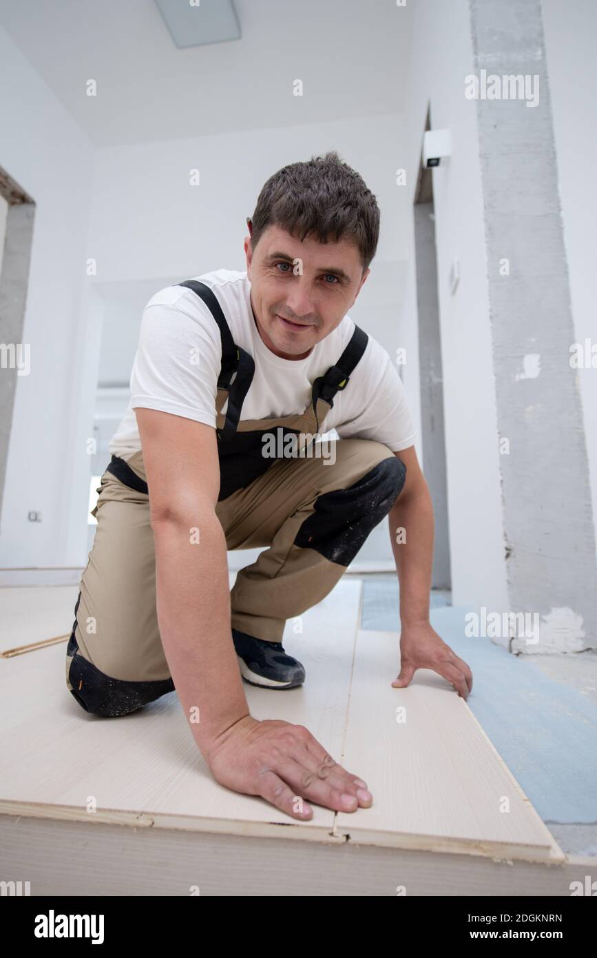 Worker Installing New Laminated Wooden Floor Stock Photo - Alamy