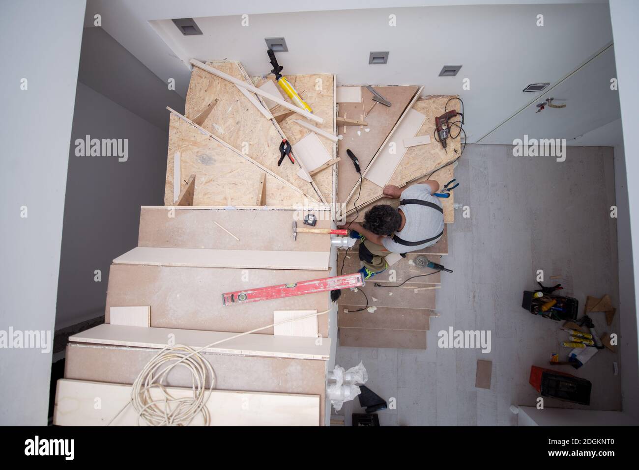 Carpenter installing wooden stairs Stock Photo - Alamy
