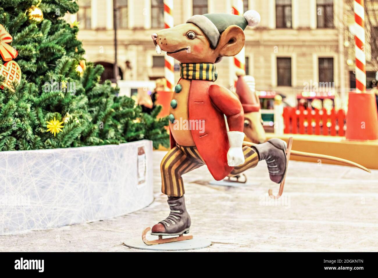 Figure of a rat on skates on an ice rink. Street city decorations ...