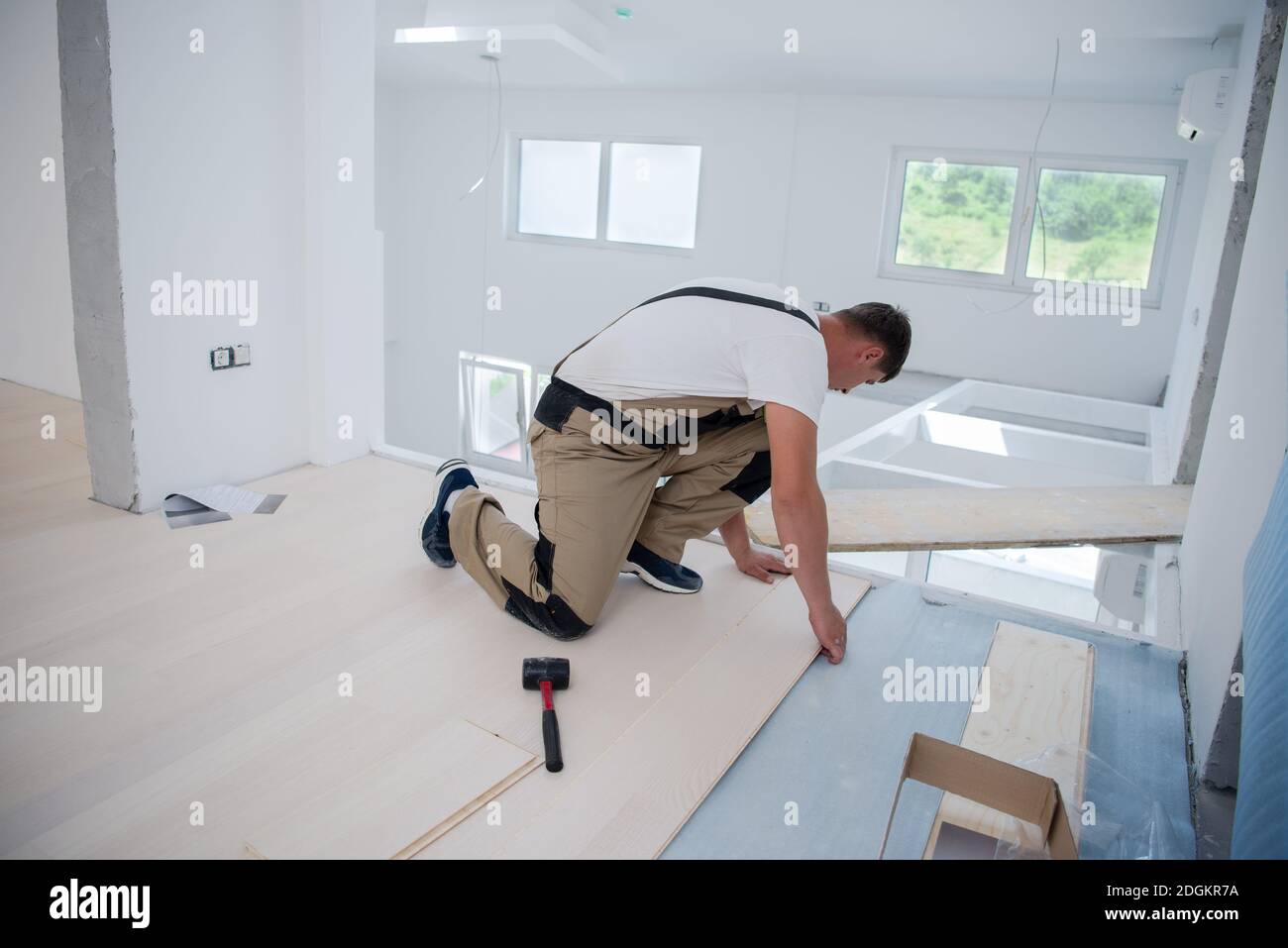 Worker Installing New Laminated Wooden Floor Stock Photo - Alamy
