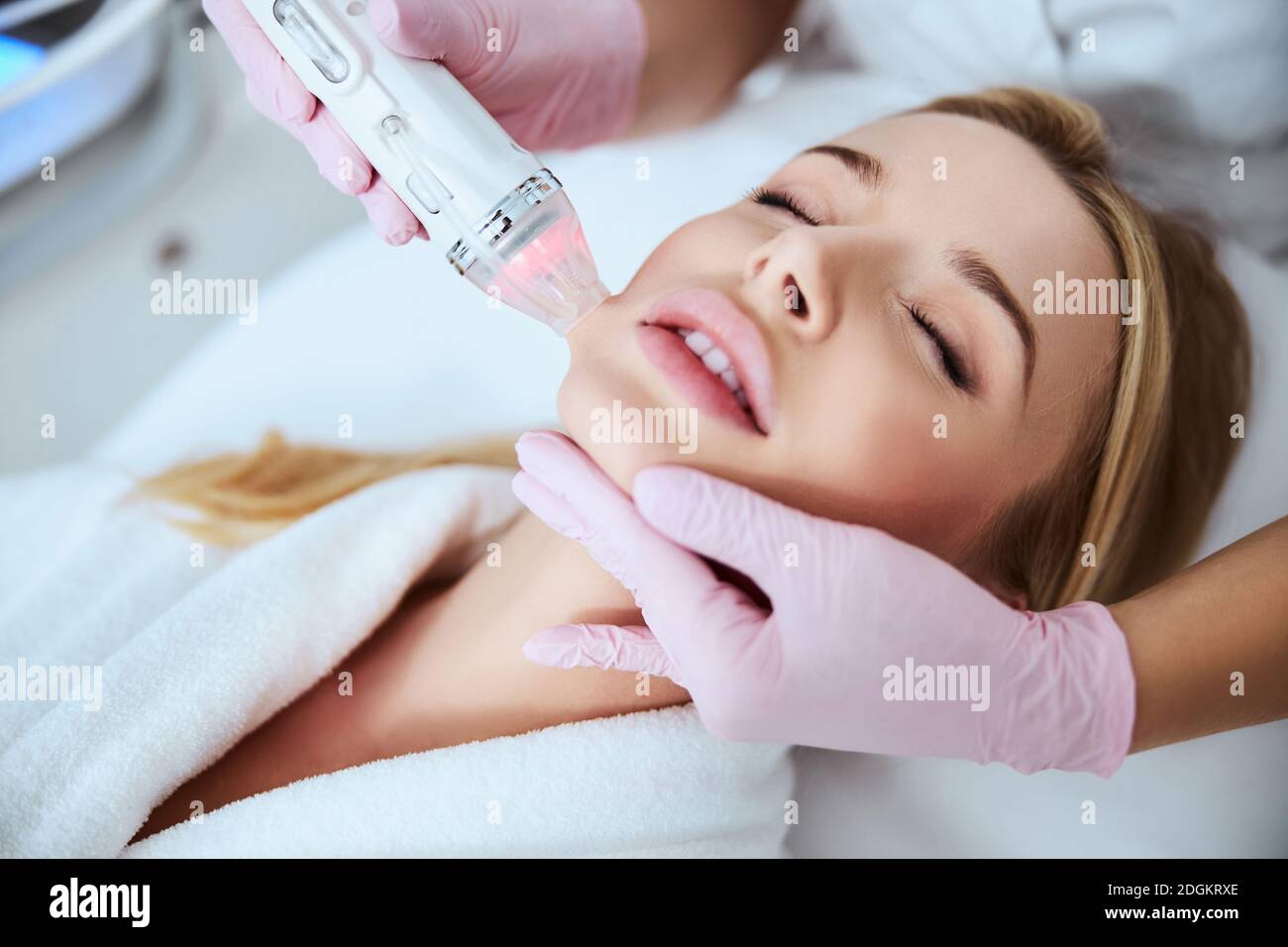 Good-looking woman patient lying still during the treatment Stock Photo ...