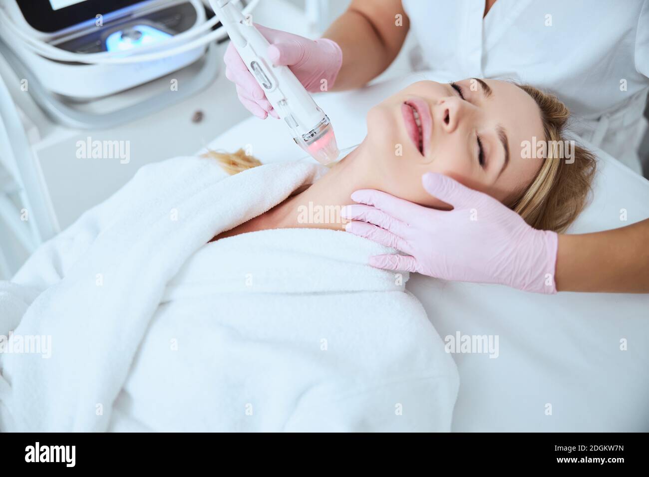 Woman being treated for fine lines on her neck Stock Photo - Alamy