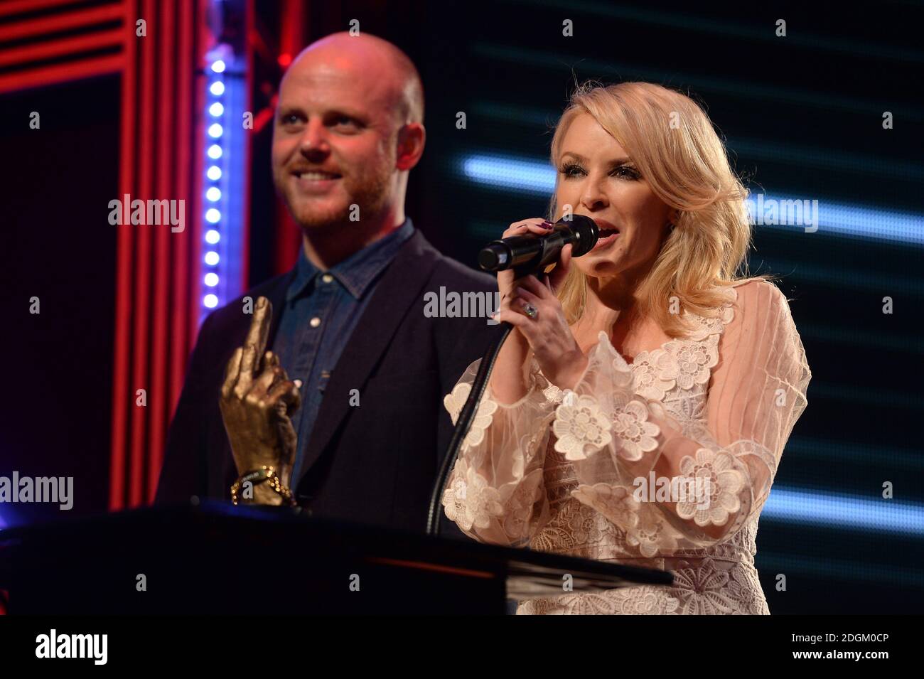 Editor of NME Mike Williams with Kylie Minogue on stage as she presents ...
