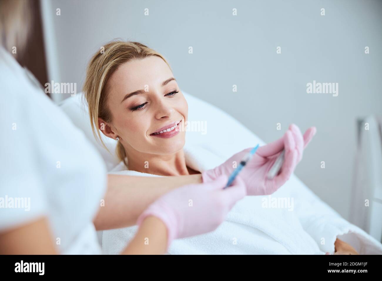 Dermatologist demonstrating the medical tools to a female patient Stock ...