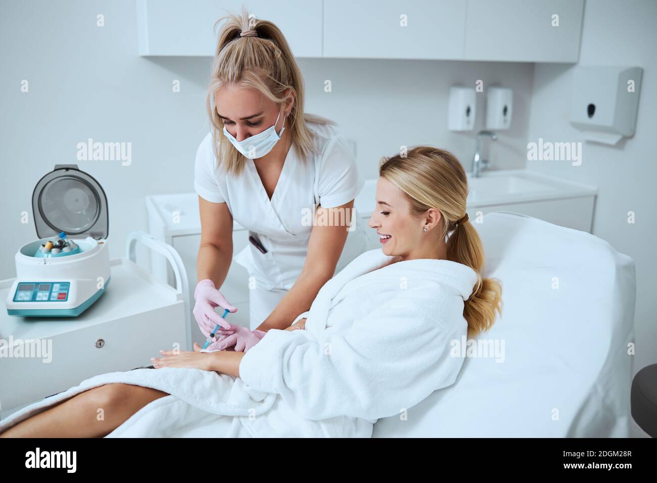 Concentrated doctor giving a platelet-rich plasma injection Stock Photo ...