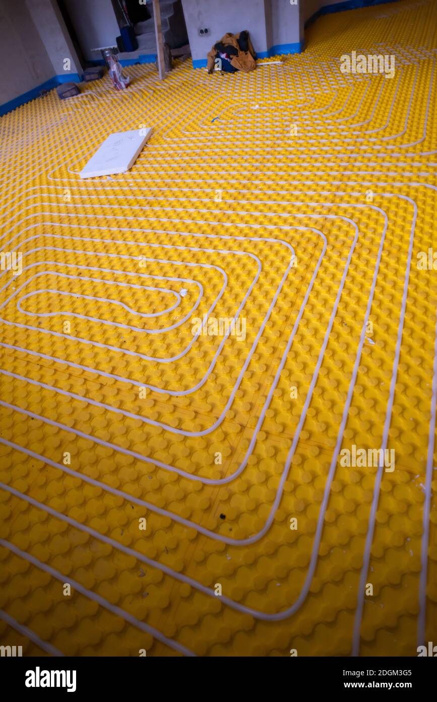 Yellow underfloor heating installation with white pipes Stock Photo - Alamy