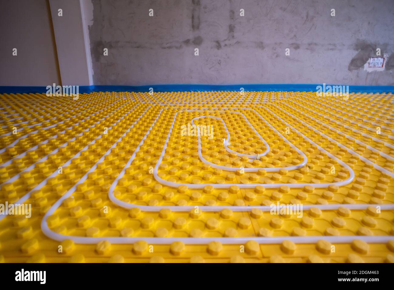 Yellow underfloor heating installation with white pipes Stock Photo - Alamy