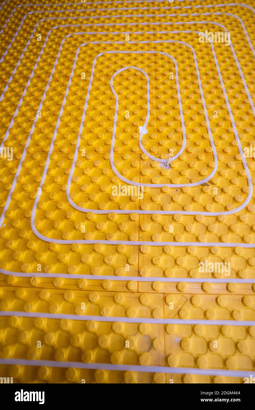 Yellow underfloor heating installation with white pipes Stock Photo - Alamy