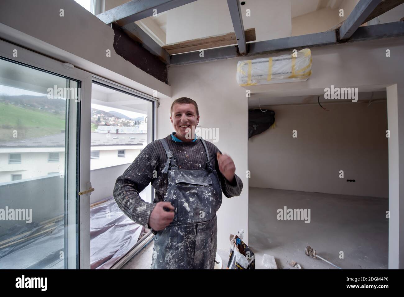 Portrait of construction worker with dirty uniform in apartment Stock ...