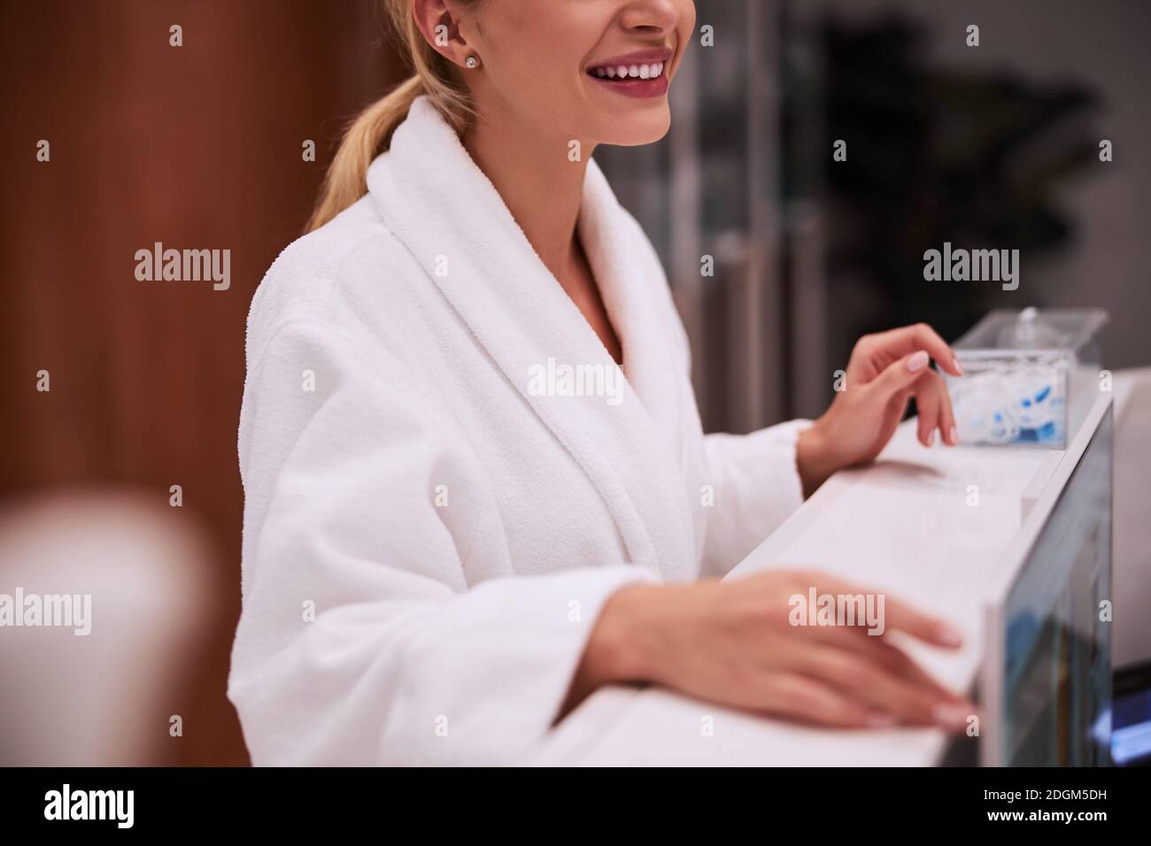Female patient standing at a reception desk Stock Photo - Alamy