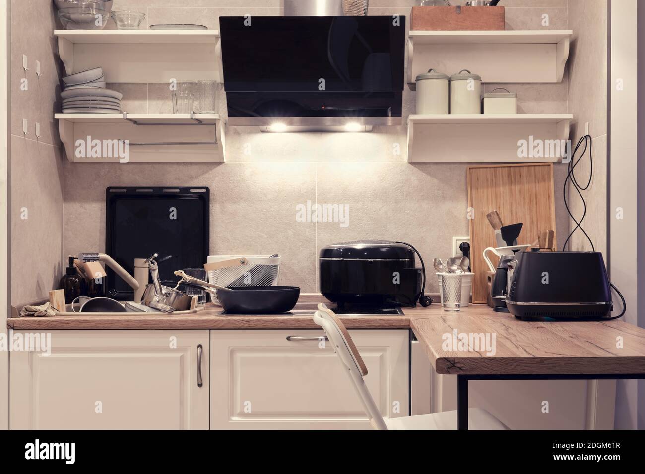 The kitchen is cluttered with dishes, appliances and items. Dirty ...