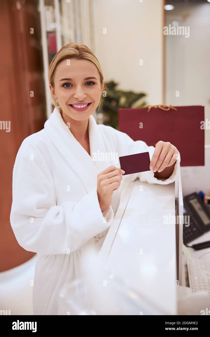 Contented client posing for the camera at the reception desk Stock ...
