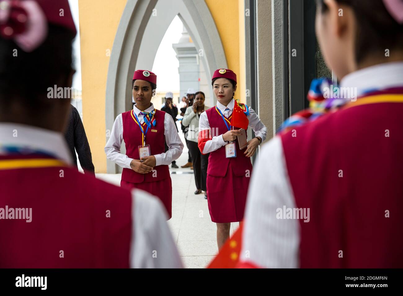 --FILE--African and Chinese railway attendants wearing standard ...