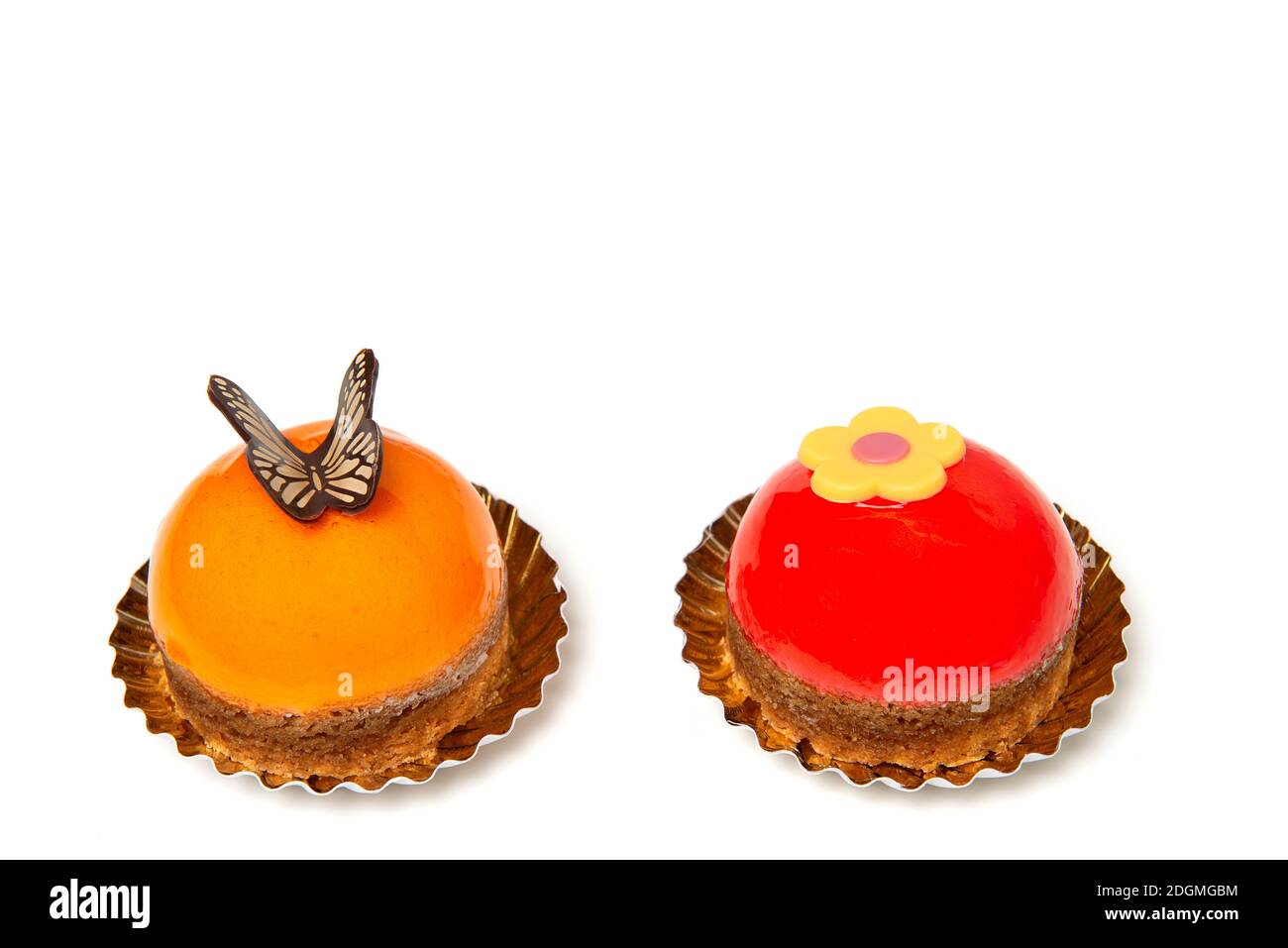 Two delicious looking small round cakes isolated on a white background ...