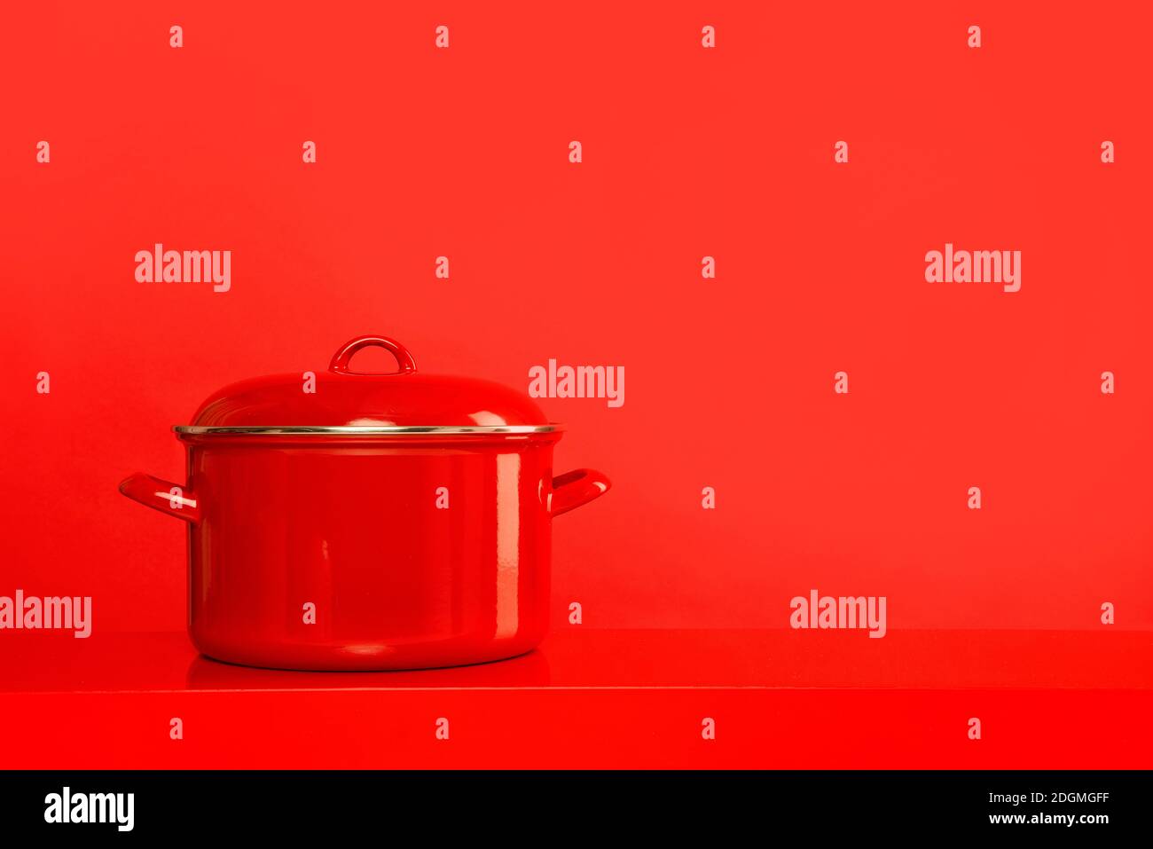 Red cooking pan on a red background with space for copy Stock Photo - Alamy