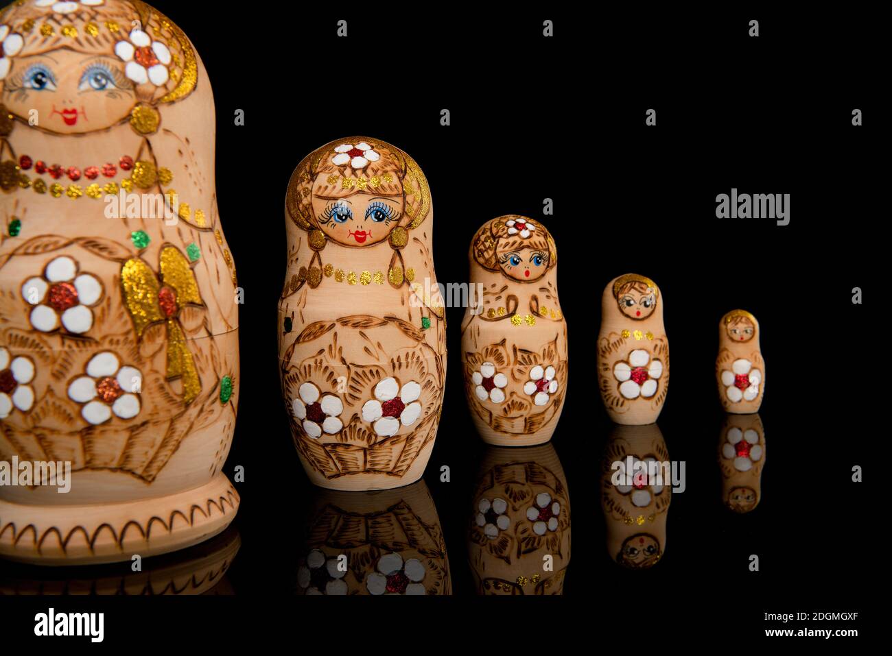 Wooden Russia matrioshka dolls in a row on a blackground Stock Photo ...