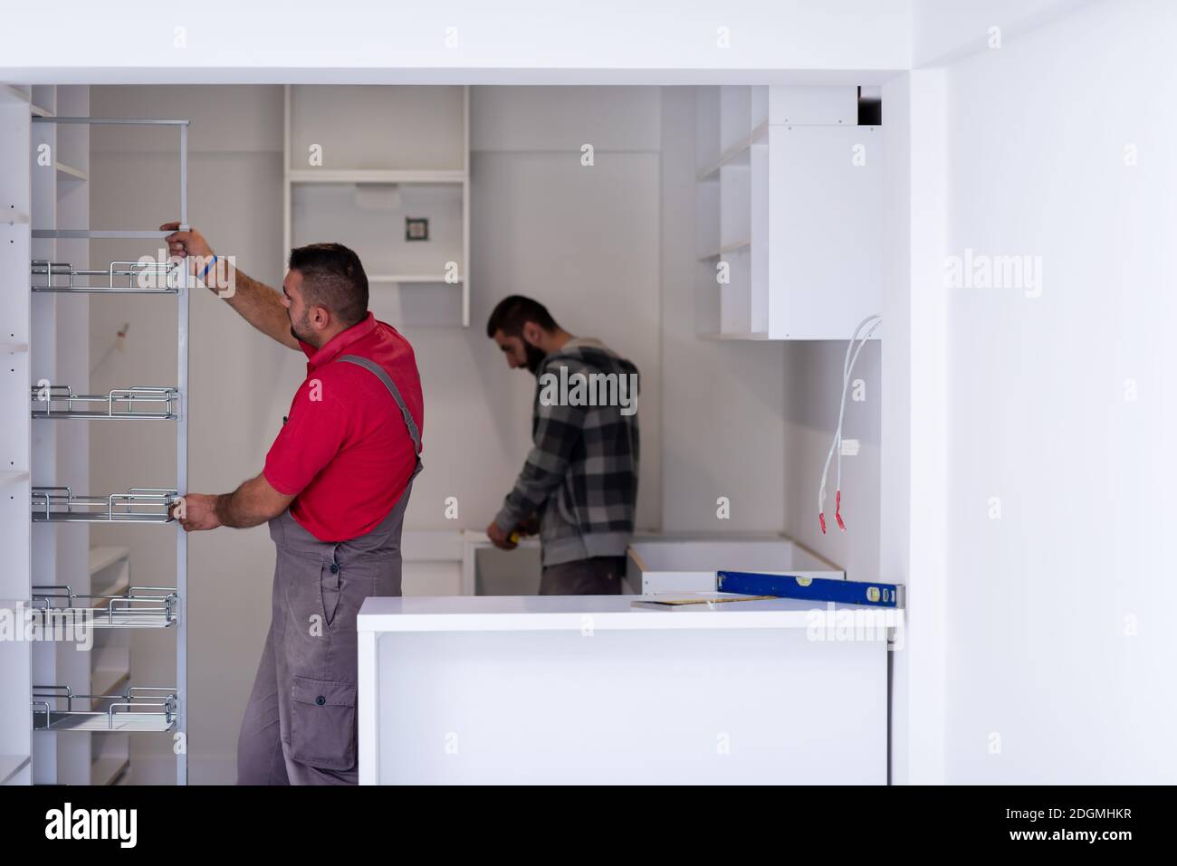 Workers installing a new kitchen Stock Photo - Alamy