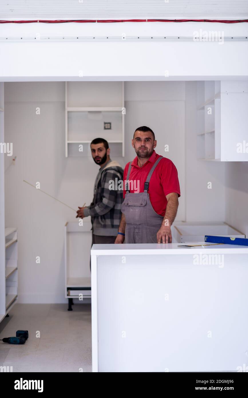 Two workers assemble equipment hi-res stock photography and images - Alamy