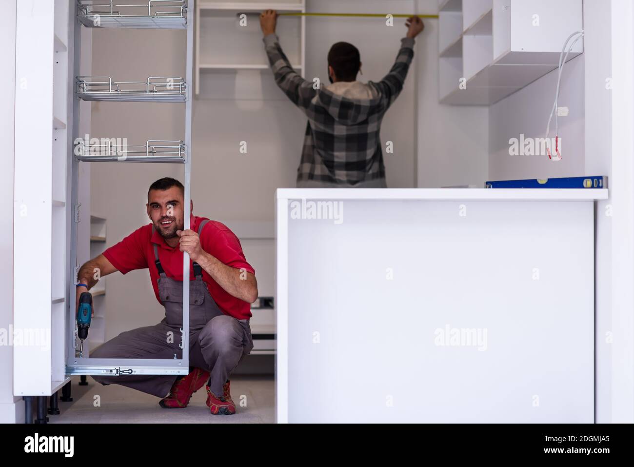 Workers installing a new kitchen Stock Photo - Alamy