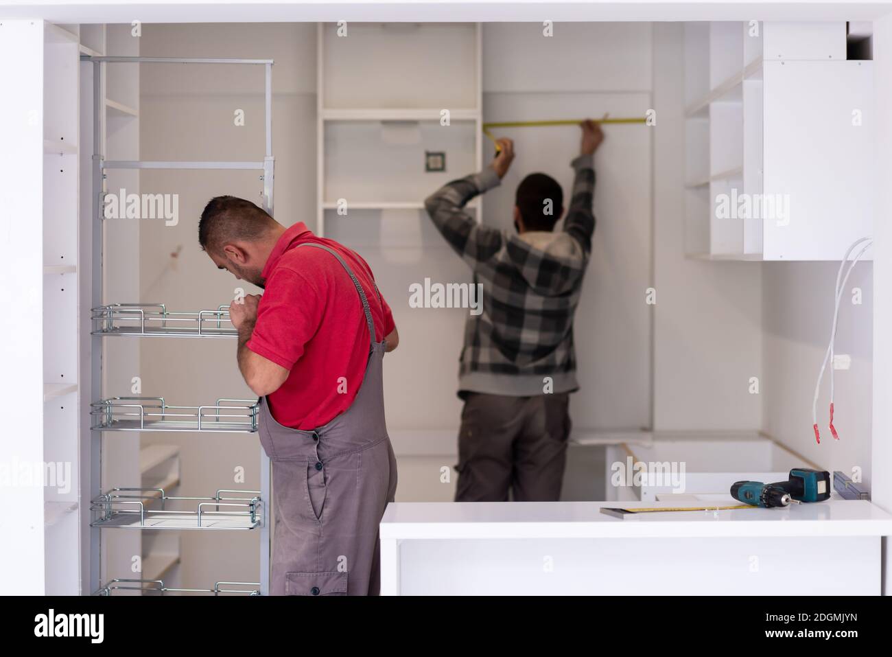 Workers installing a new kitchen Stock Photo - Alamy