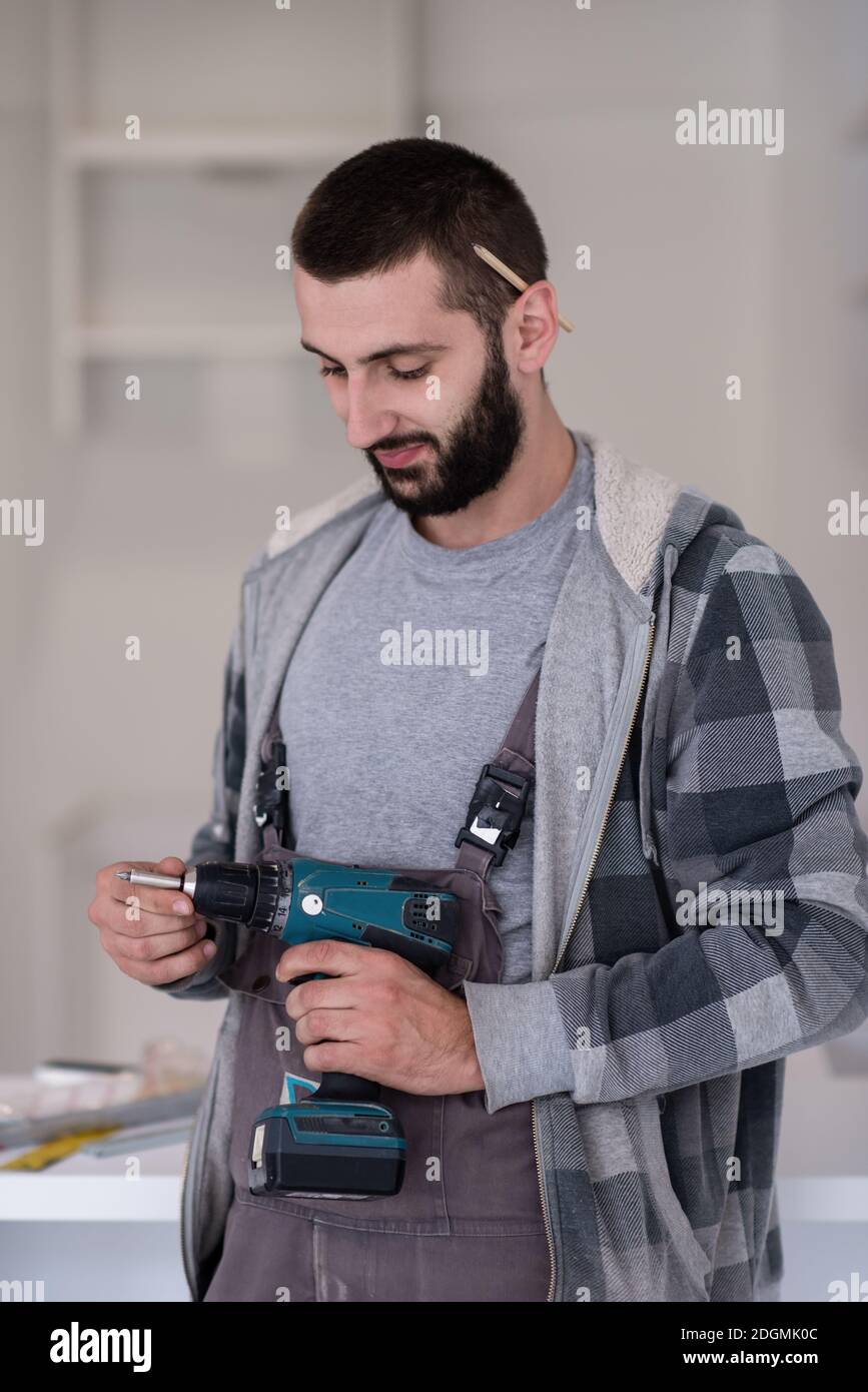 The worker holding a hand drilling machine Stock Photo - Alamy