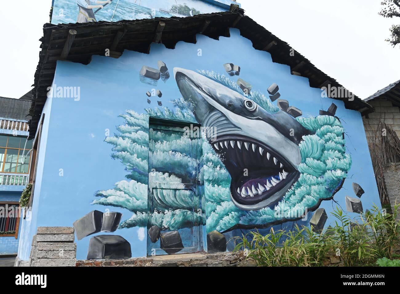 The walls of houses in a village are painted with colorful graffiti ...