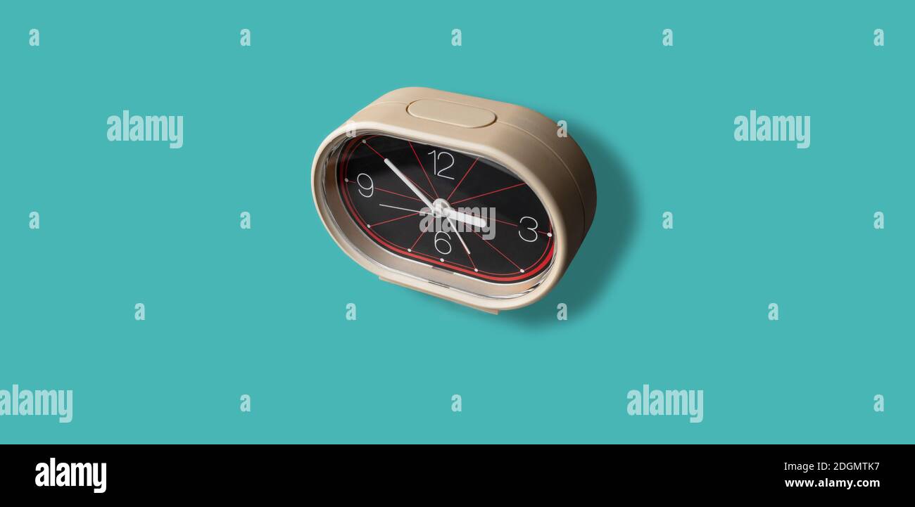 Analog retro alarm clock on cyan background. Copy space Stock Photo - Alamy