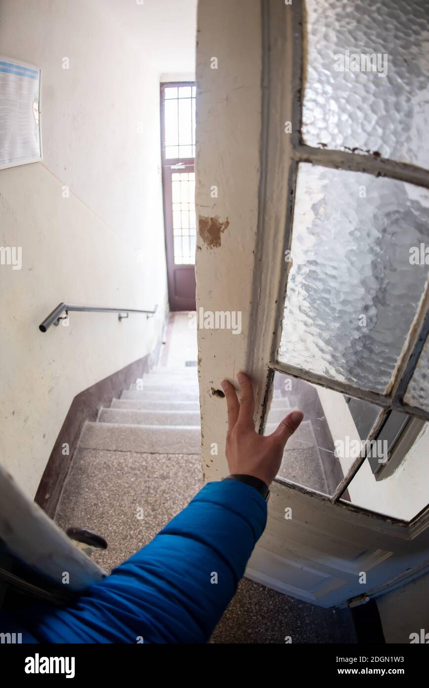 Man opening door of a building Stock Photo - Alamy