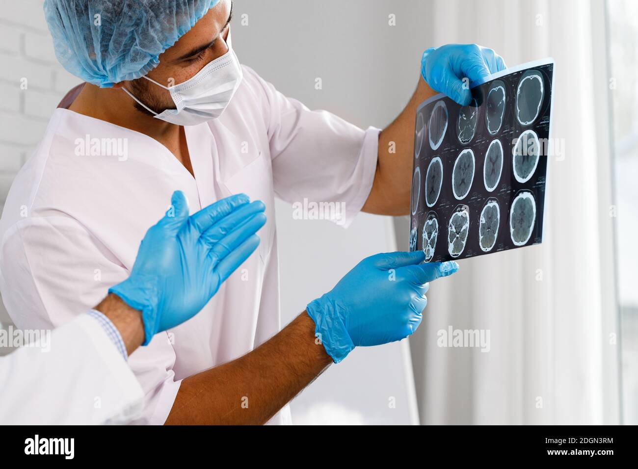 Male doctor examines MRI brain scan of a patient Stock Photo - Alamy