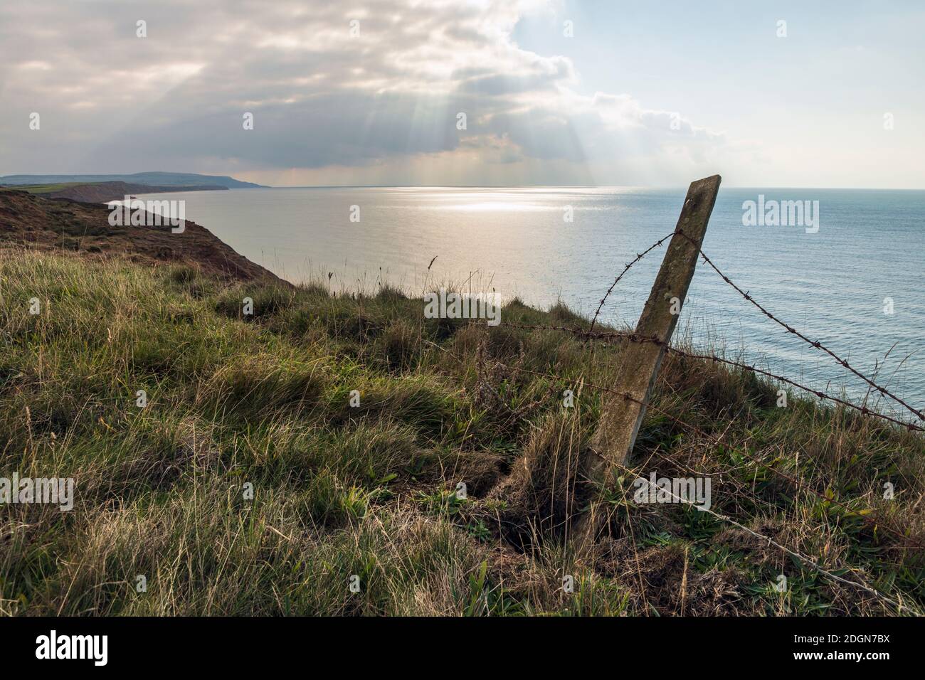 A cliff edge fence which has collapsed due to coastal erosion ...
