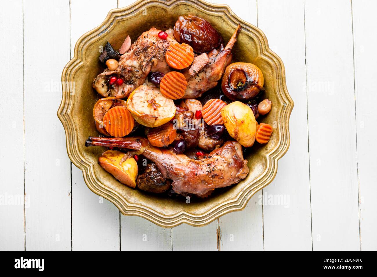 Delicious baked rabbit meat with fruits on white background Stock Photo ...