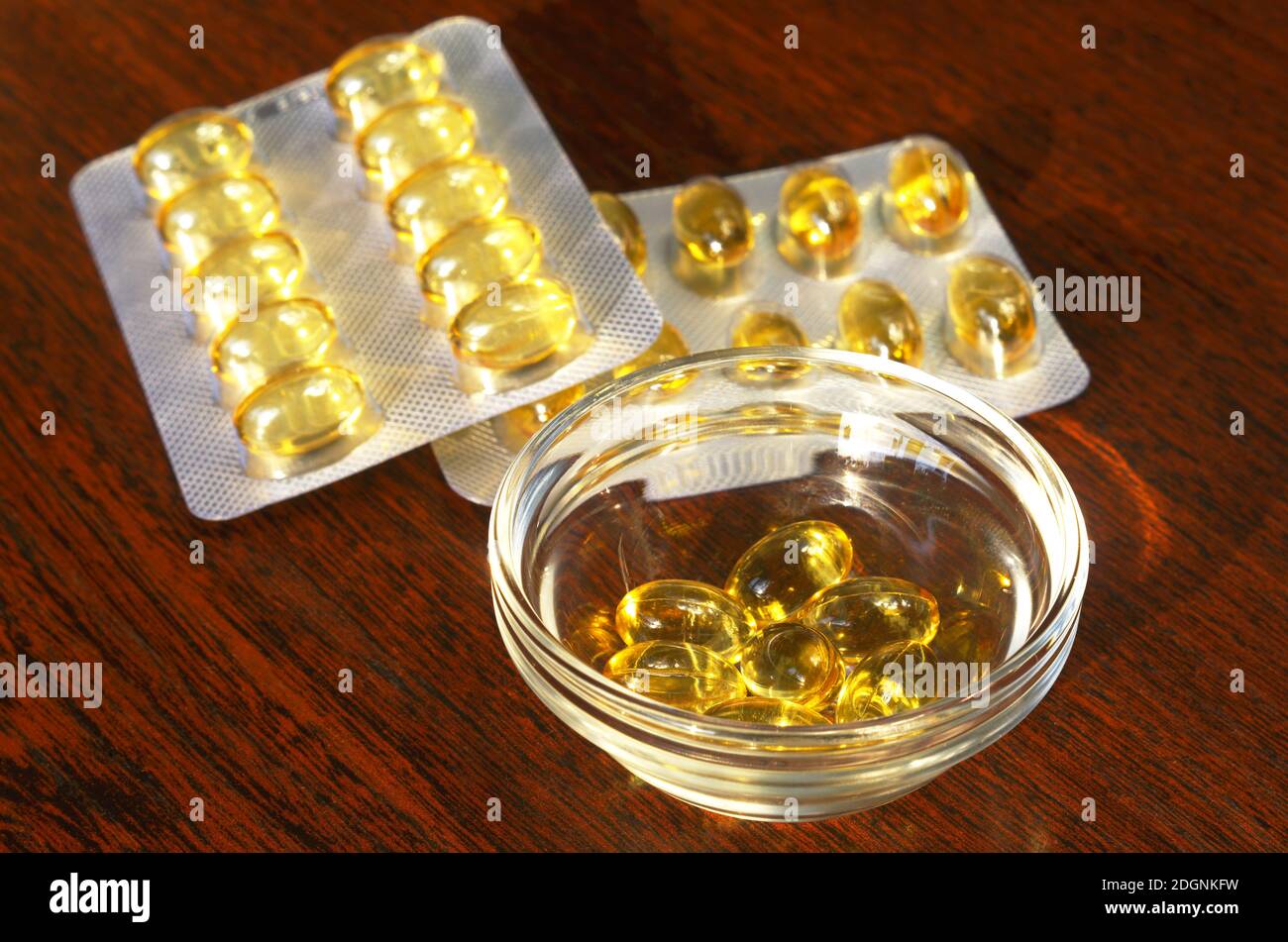 Fish oil capsules on old brown wooden table Stock Photo - Alamy