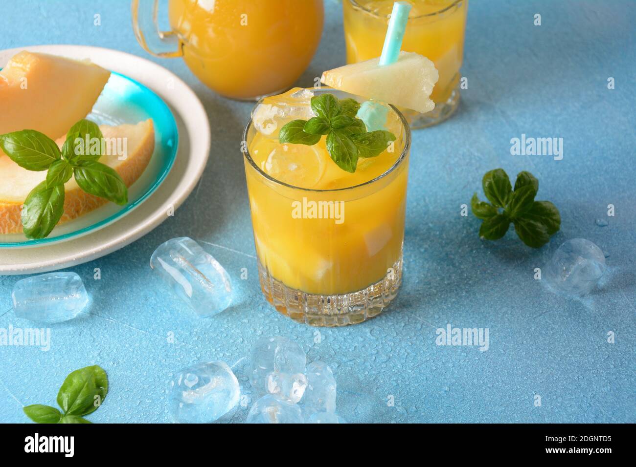 Refreshing drinks and citrus juices with ice cubes, mint and melon ...