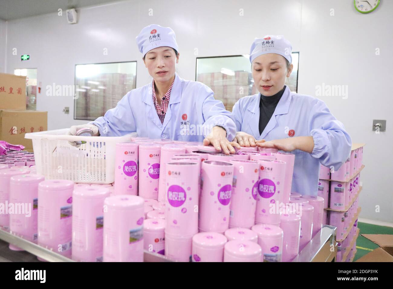 Workers pack tea in a factory in Tonglu county, Hangzhou city, east ...